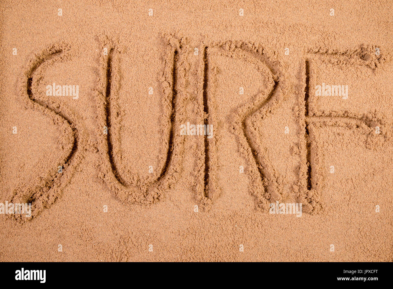 Surf written in soft wet sand on a beach Stock Photo - Alamy