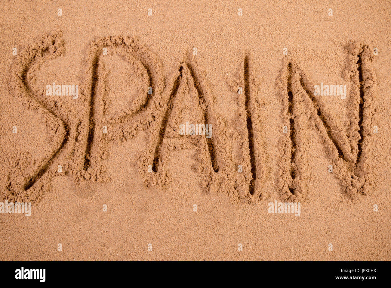 Spain written in soft wet sand on a beach Stock Photo - Alamy