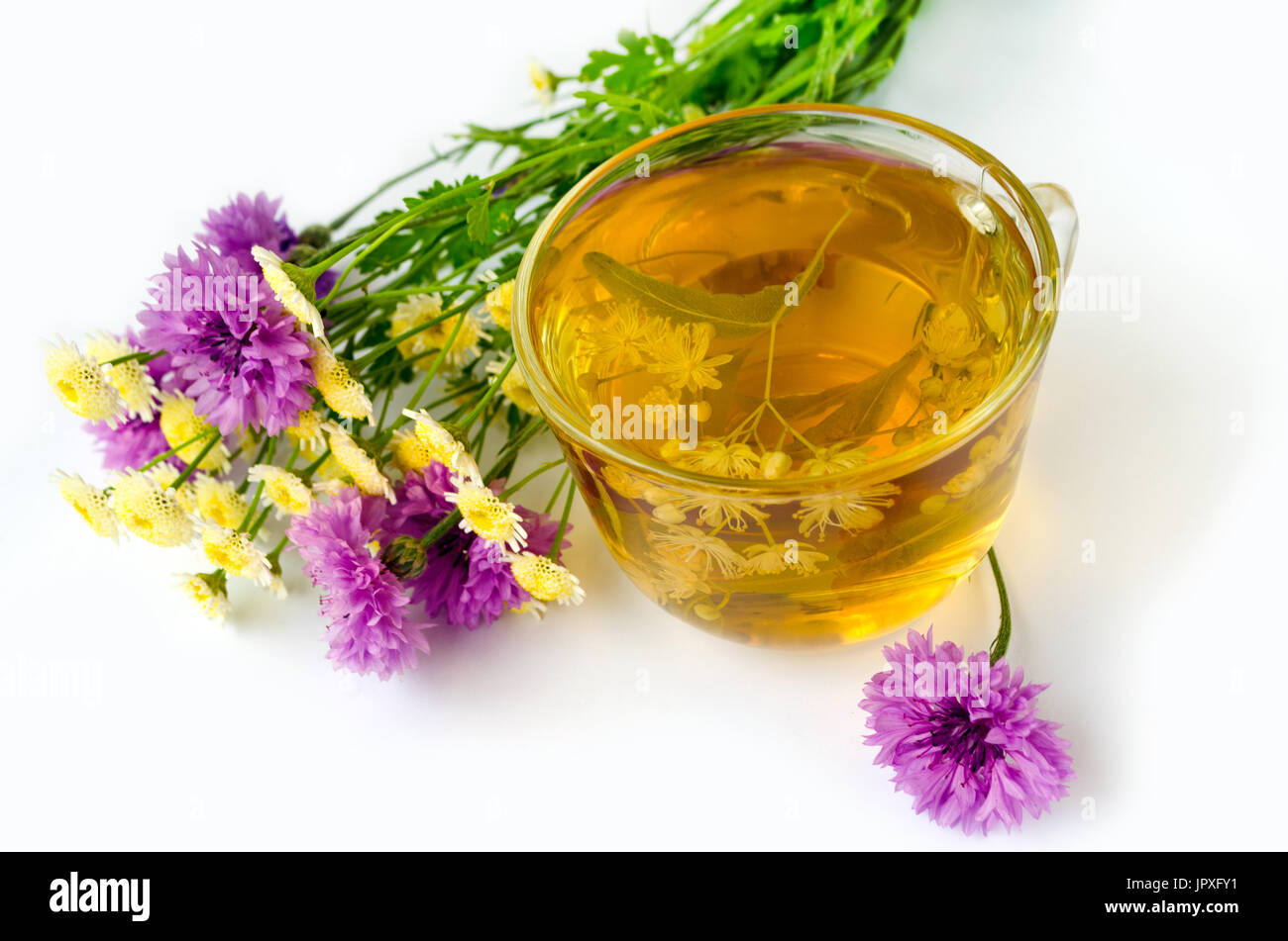 Natural therapy - Lime Tea in a transparent cup on a white background ...