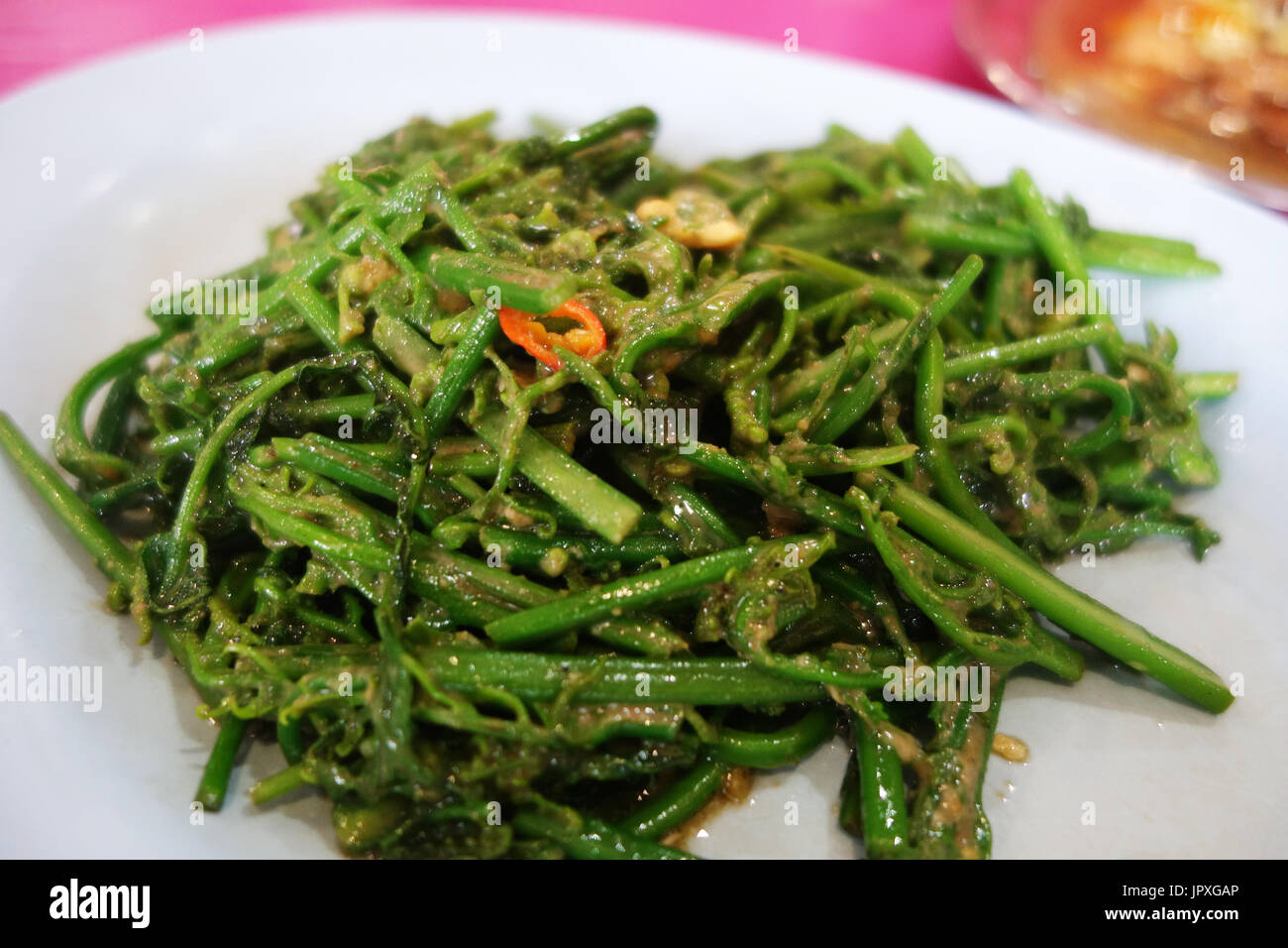 Home cooked stir fried vegetable fern spikes Stock Photo - Alamy