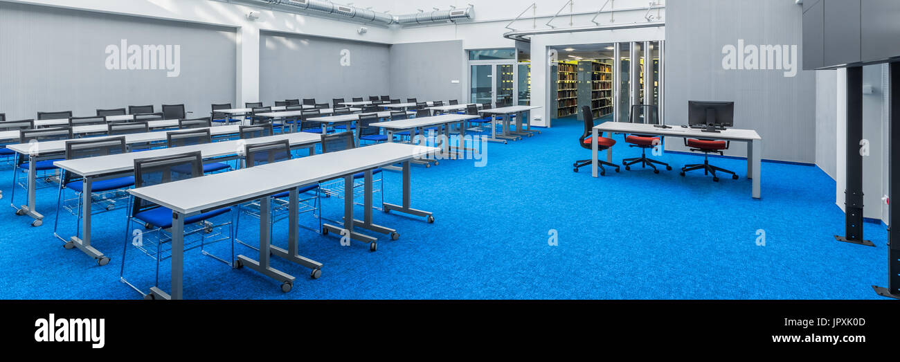 Panorama of modern and bright university meeting room in grey and blue ...