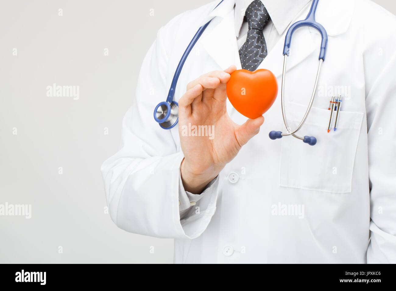 Doctor holding toy-heart in hand Stock Photo - Alamy
