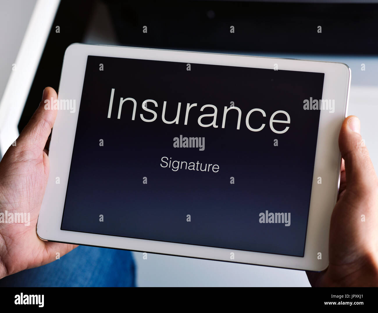 closeup of a young caucasian man about to sign an insurance policy in a ...