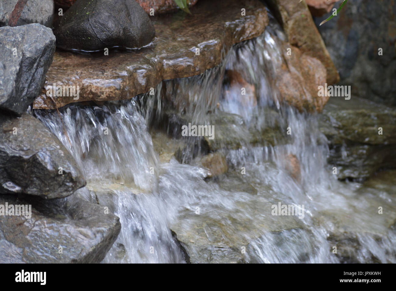 Small waterfall over the rocks Stock Photo - Alamy