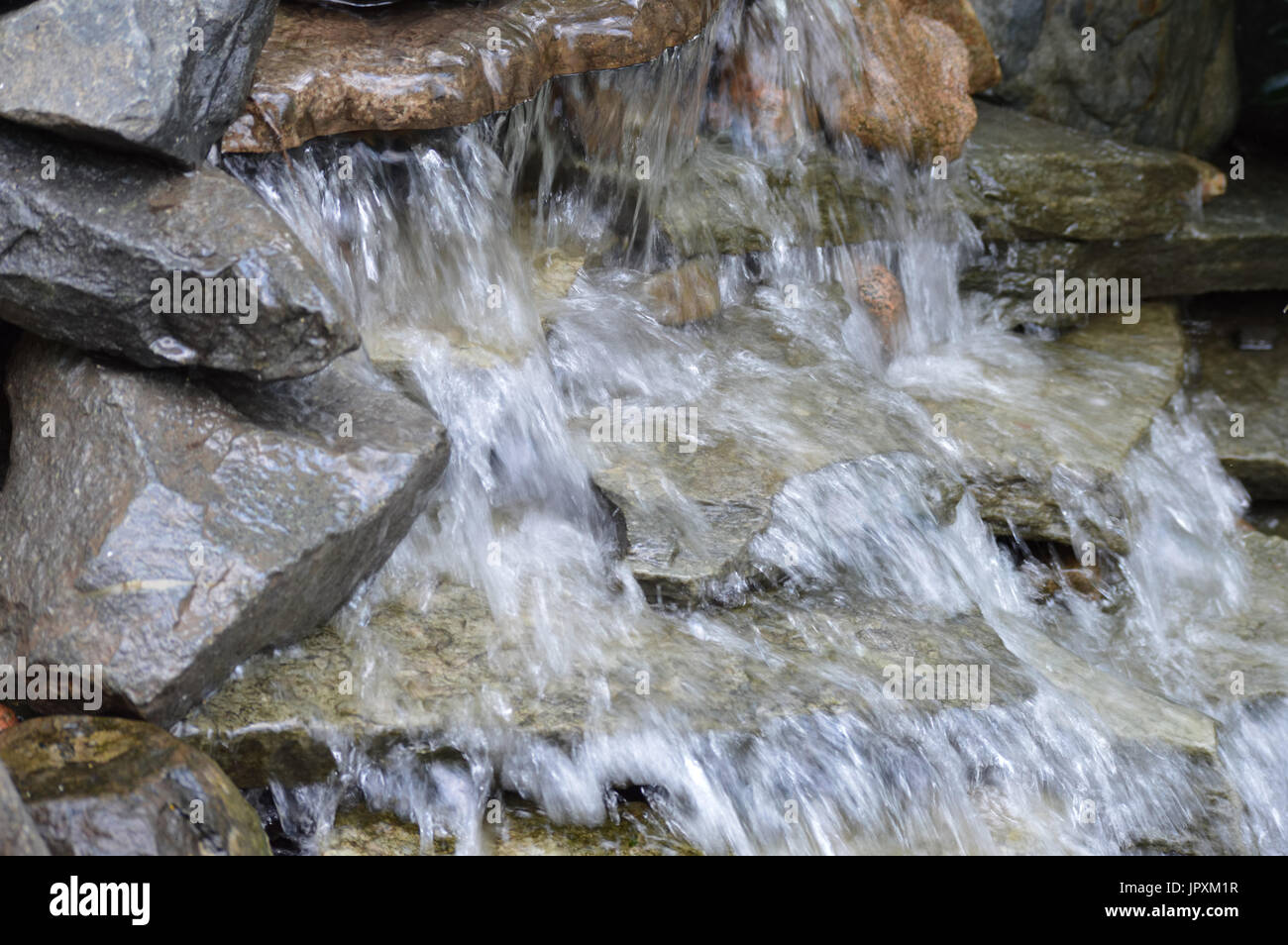 Small waterfall over the rocks Stock Photo - Alamy