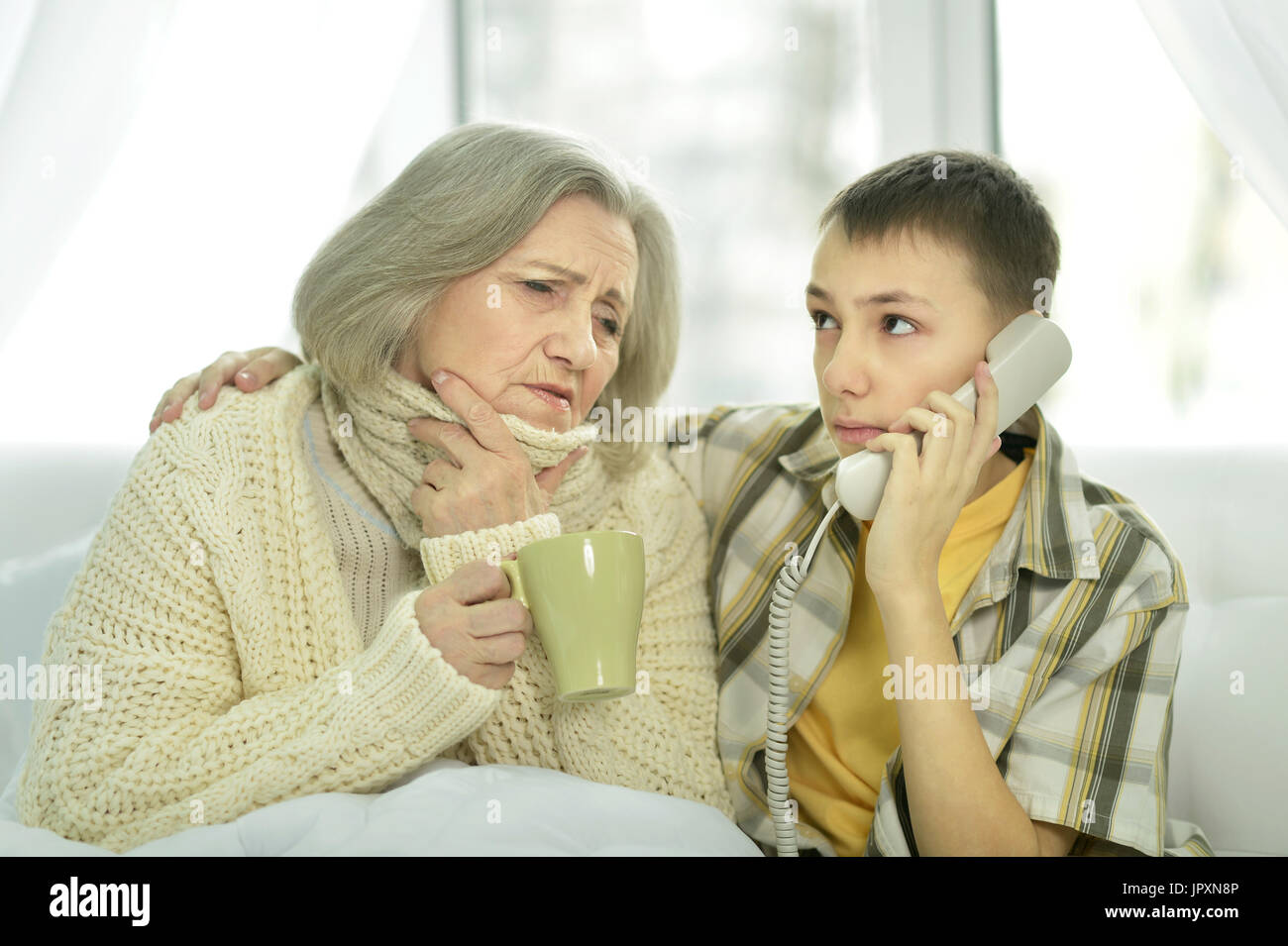 little boy taking care of his ill grandmother and calling ambulance ...