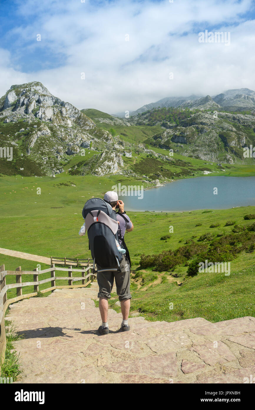 Family trip to Spain nature: father with a baby in a backpack hiking on ...