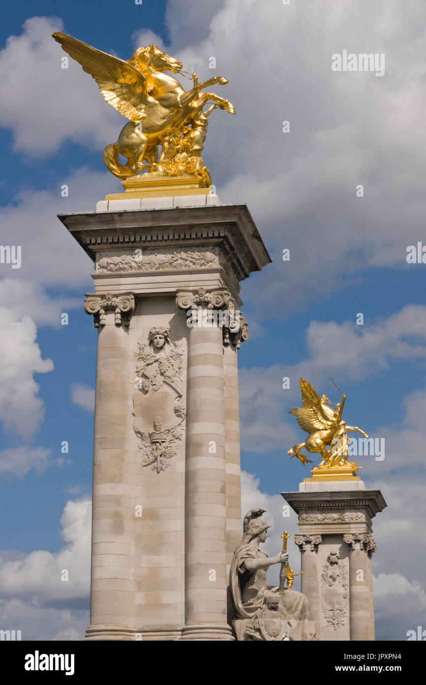 Golden statues of winged horses on top of pillars decorate the Pont ...