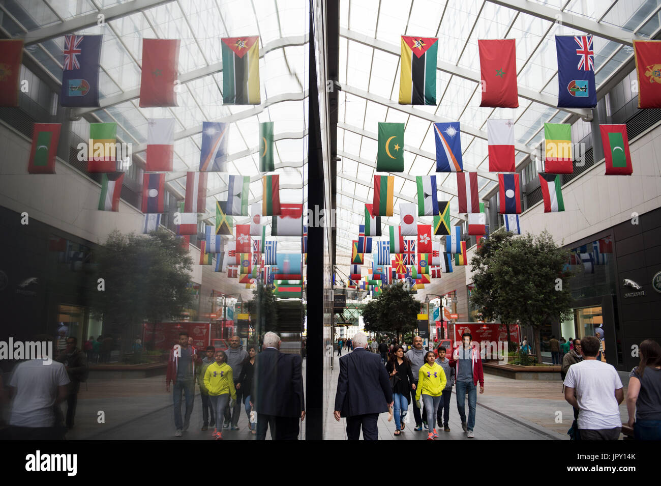 London, UK. 2nd Aug, 2017. National flags hang above the heads of ...