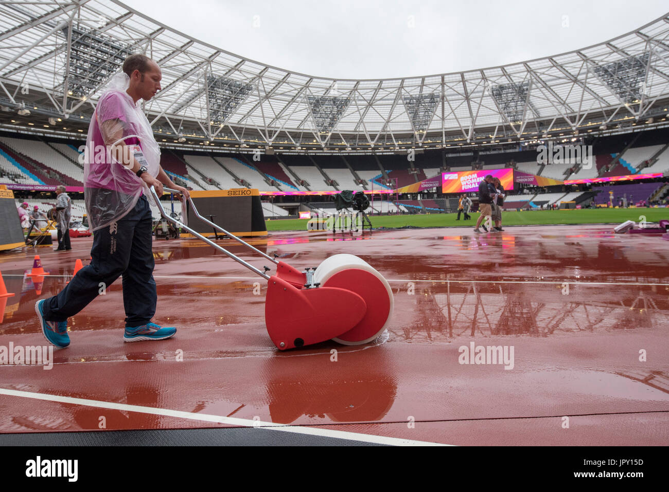 London, UK. 2nd Aug, 2017. Staff use giant rollers to mop up water at ...