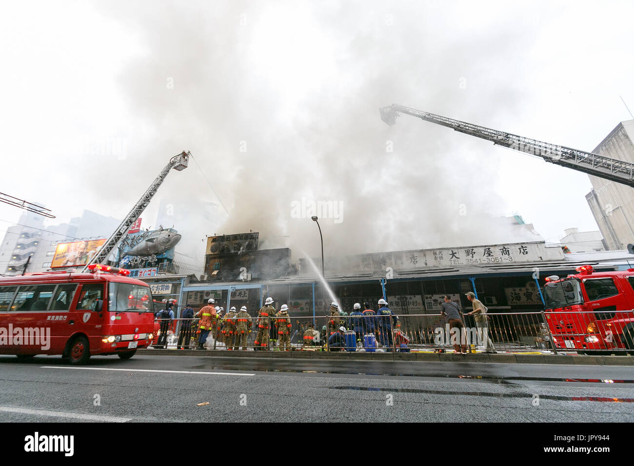 Tokyo, Japan. 3rd July, 2017. Fire fighters try to bring a fire under ...