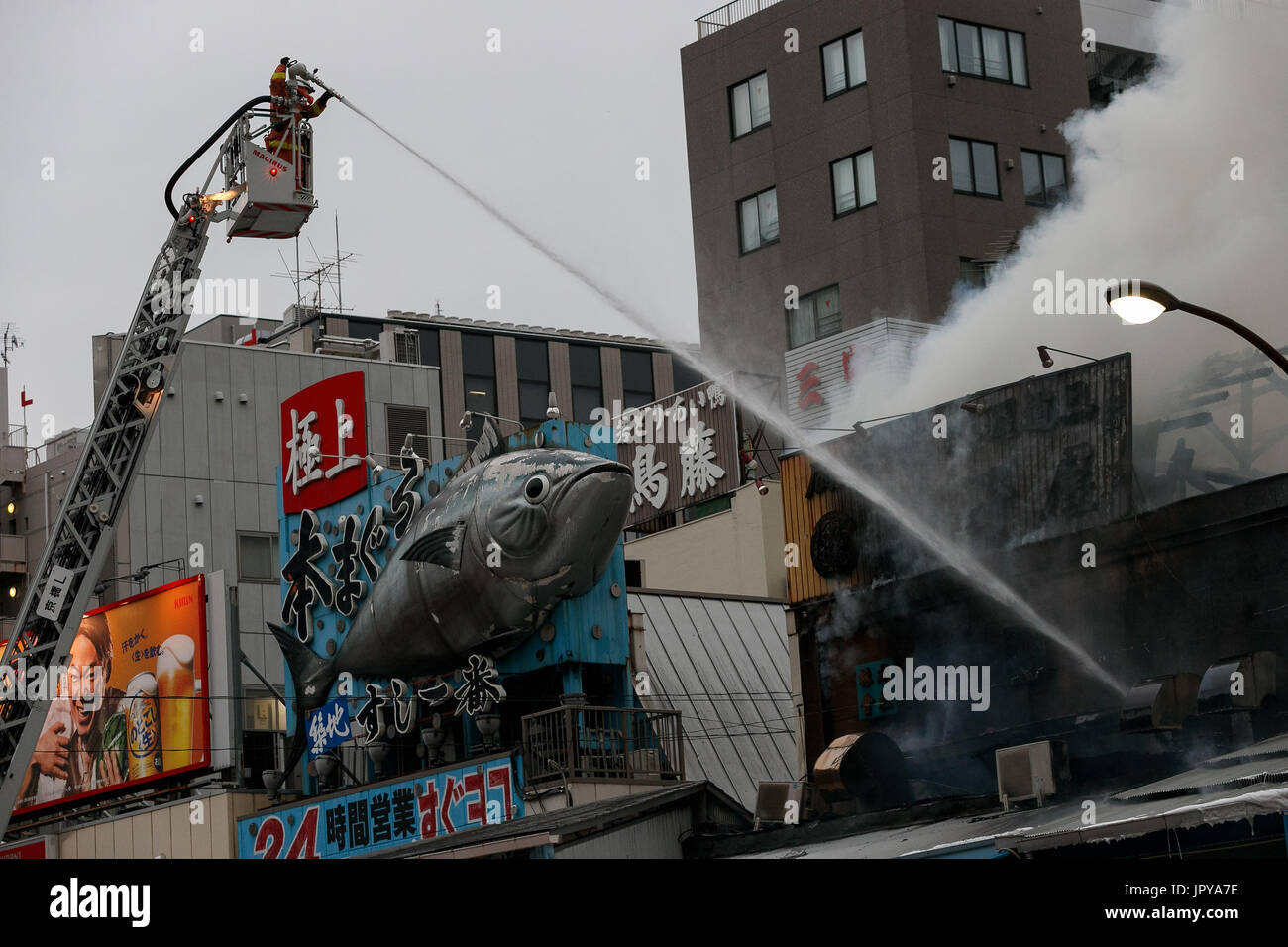 Tokyo, Japan. 3rd July, 2017. A firefighter tries to bring a fire under ...
