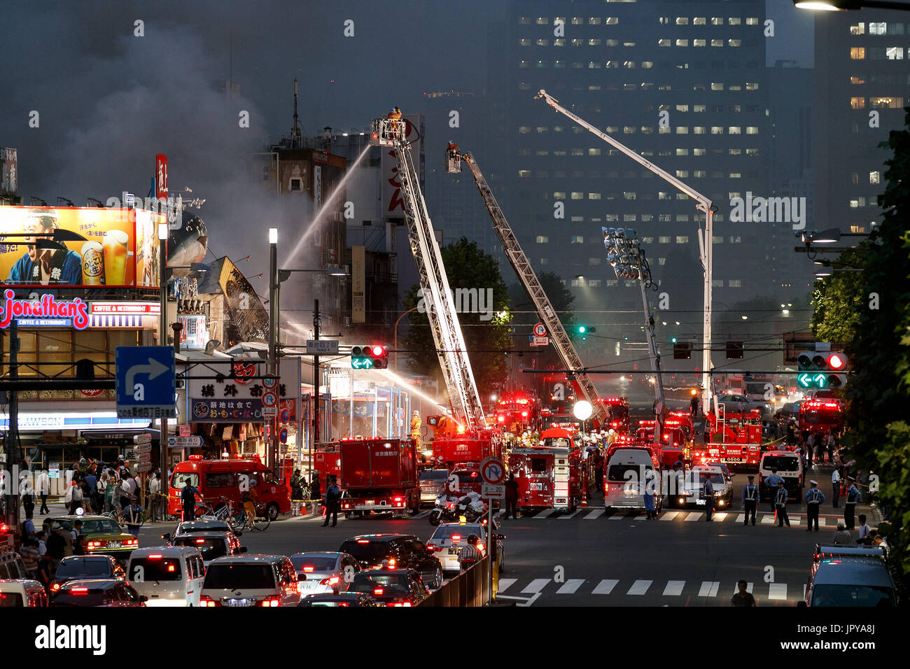 Tokyo, Japan. 3rd July, 2017. Firefighters try to bring a fire under ...