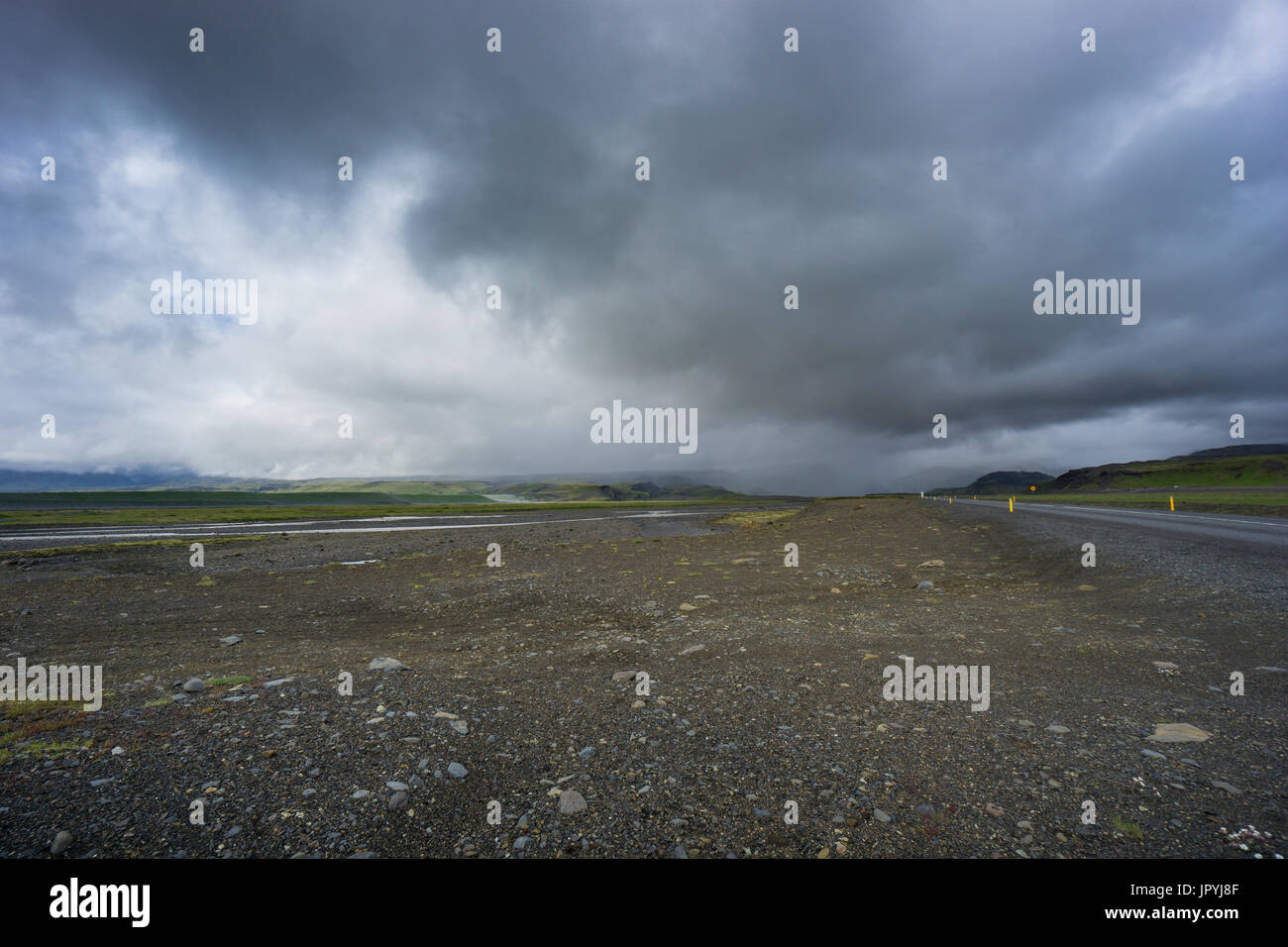 Iceland - Rain clouds and volcanic ground Stock Photo - Alamy