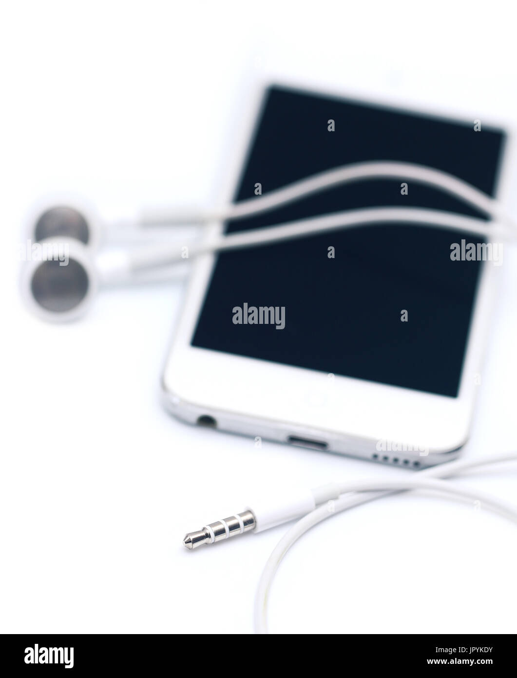 A white MP3 player with headphones on a white background Stock Photo ...