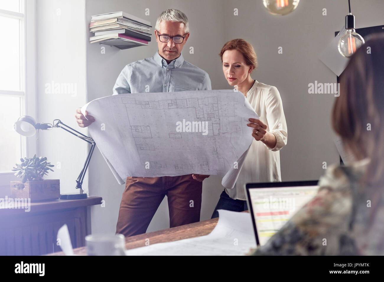 Reviewing blueprints in office hi-res stock photography and images - Alamy