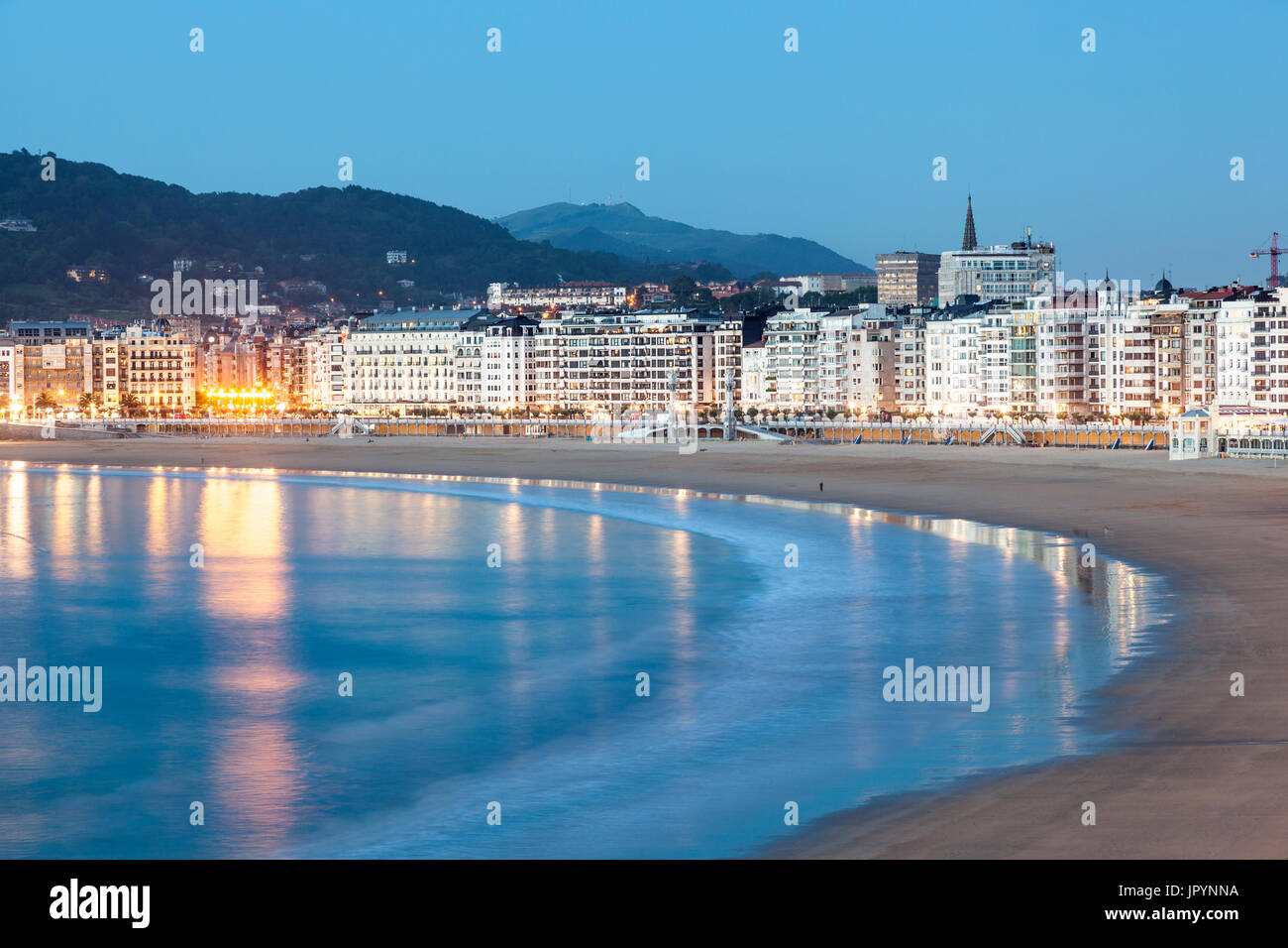 Waterfront buildings in San Sebastian illuminated at night. Basque ...