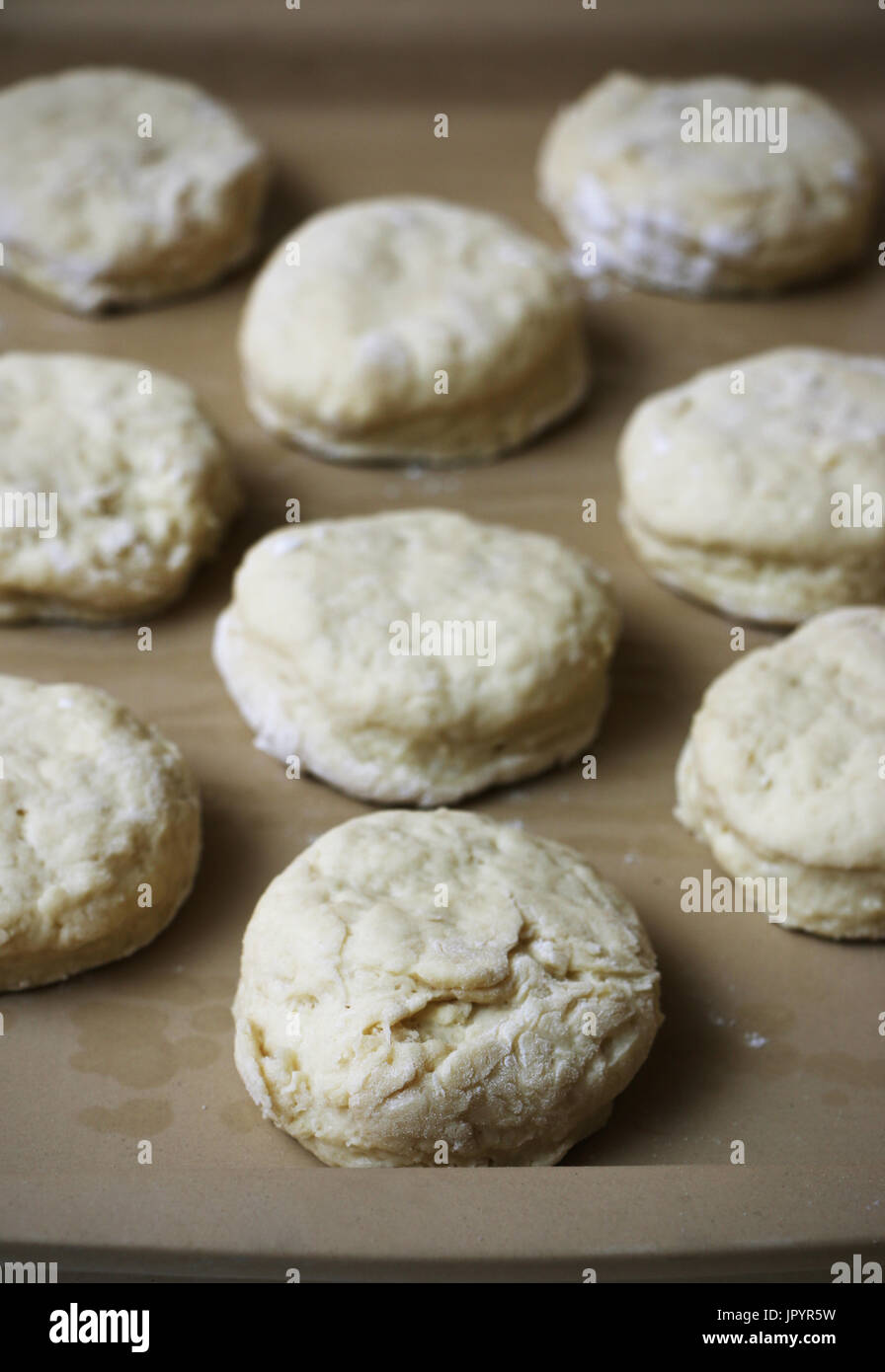 Raw biscuits rising on a cooking stone Stock Photo - Alamy