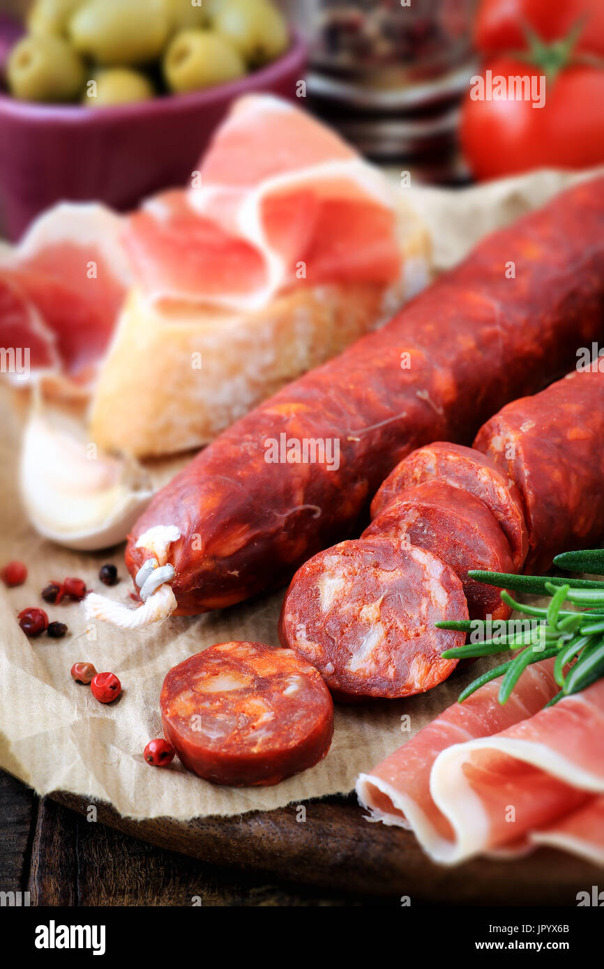 Spanish tapas - slices chorizo, jamon serrano, olives and bread Stock ...