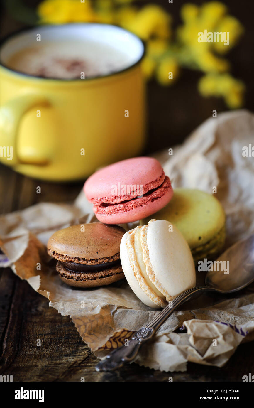 Delicious French macaroons on sack kraft paper with cappuccino coffee ...
