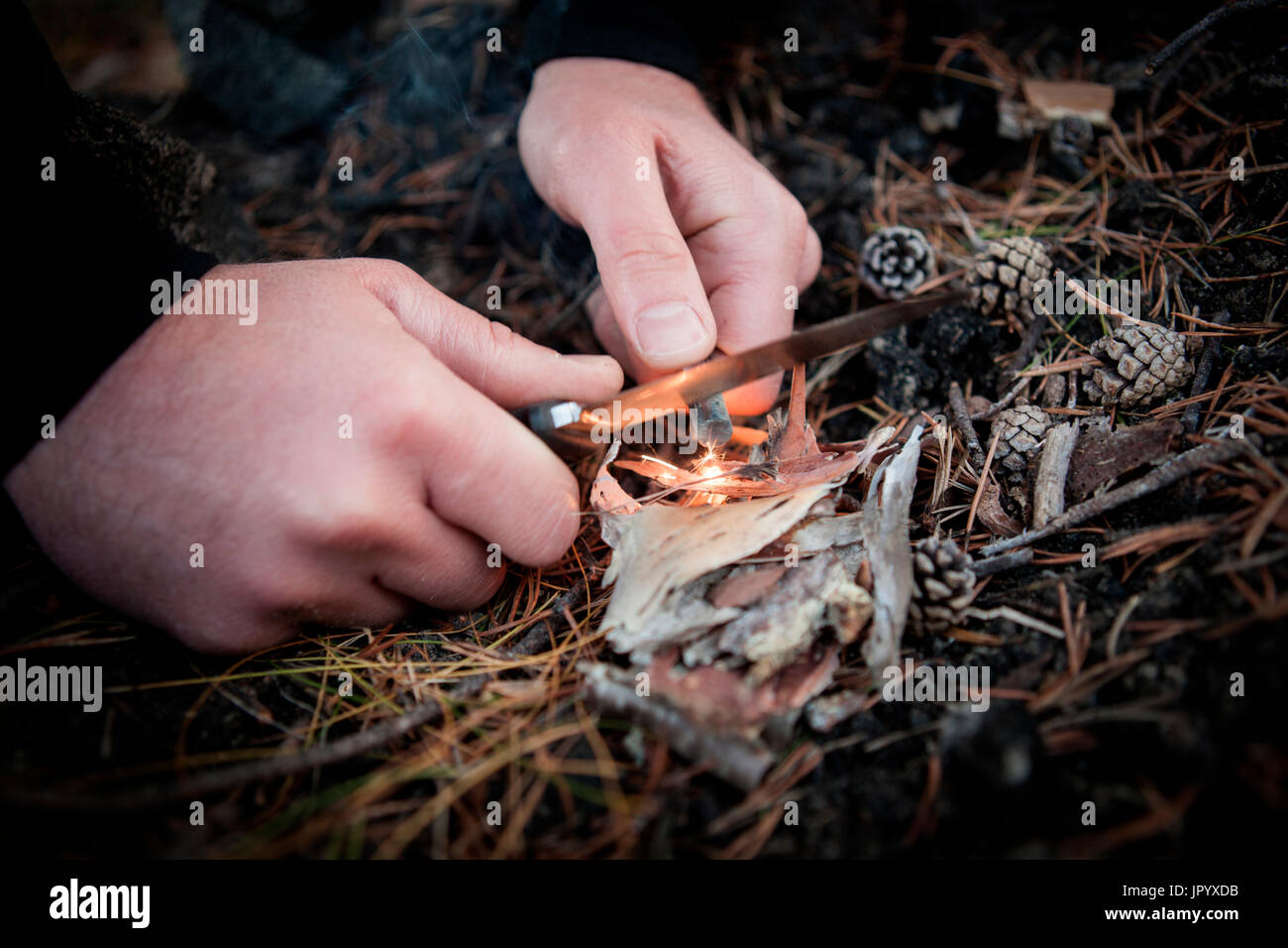 Lighting of a fire from a fire stone "Firesteel - Light My Fire", with ...