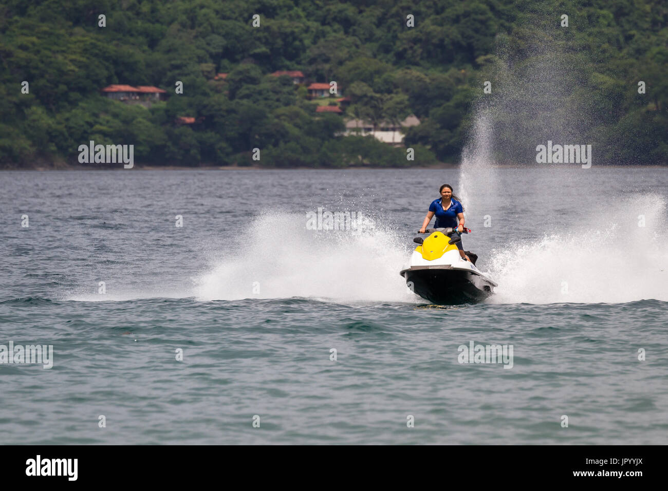 Guanacaste, Costa Rica- July 25: young woman riding a wave runner in ...