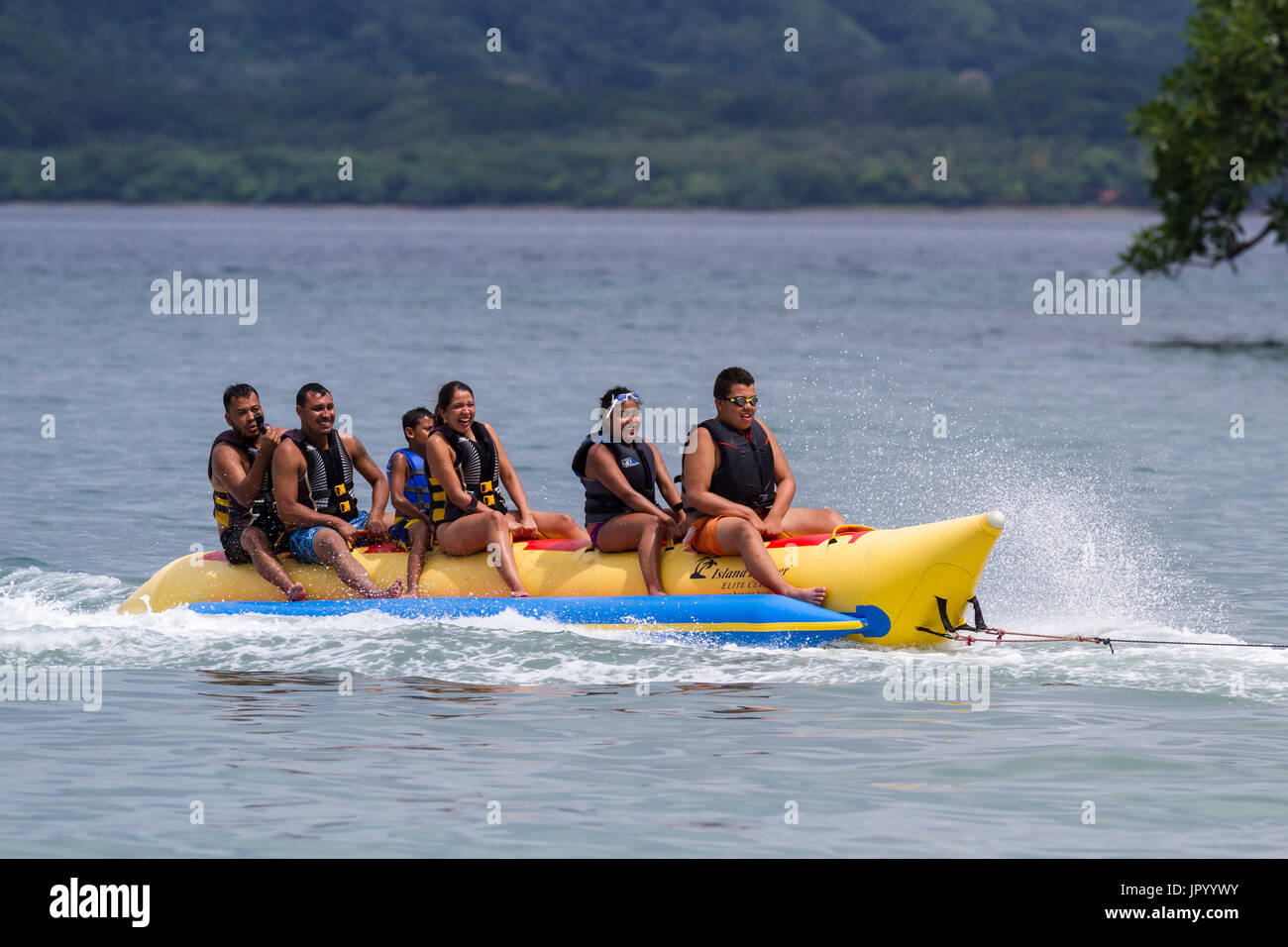 Guanacaste, Costa Rica- July 25: Family enjoying a banana boat ride in ...