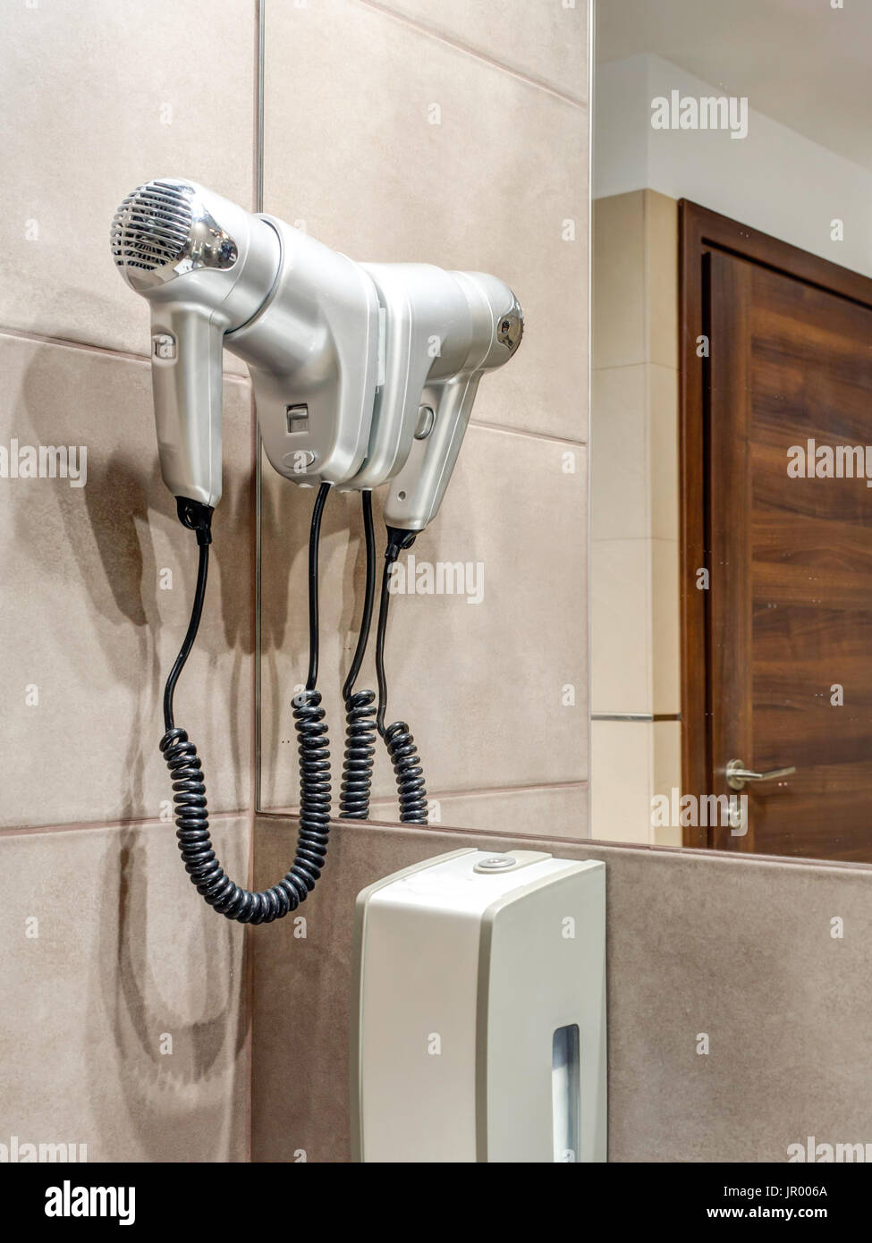 Silver dryer and its reflection in the mirror Stock Photo - Alamy