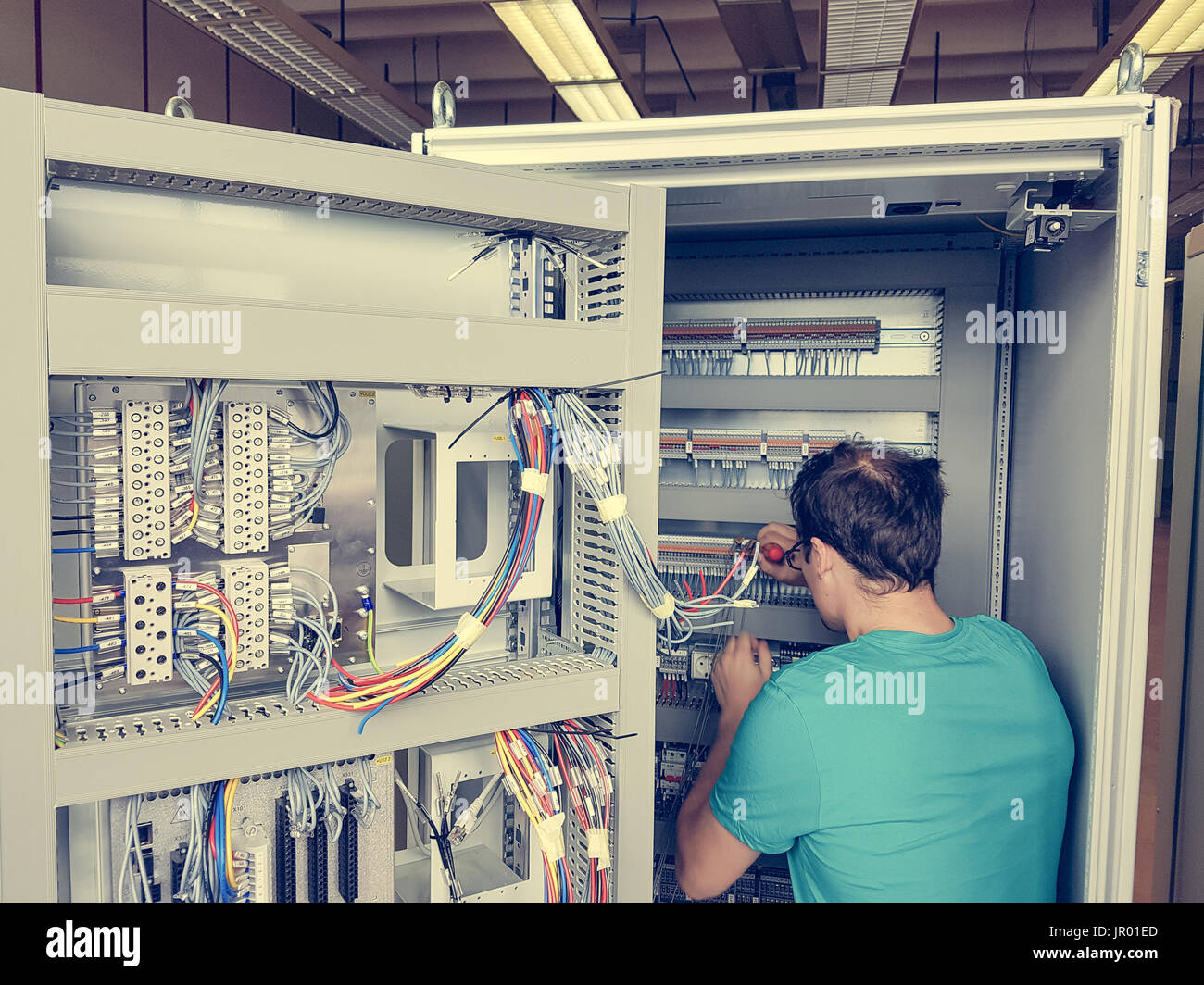 Electrical engineer configuring wires Stock Photo - Alamy