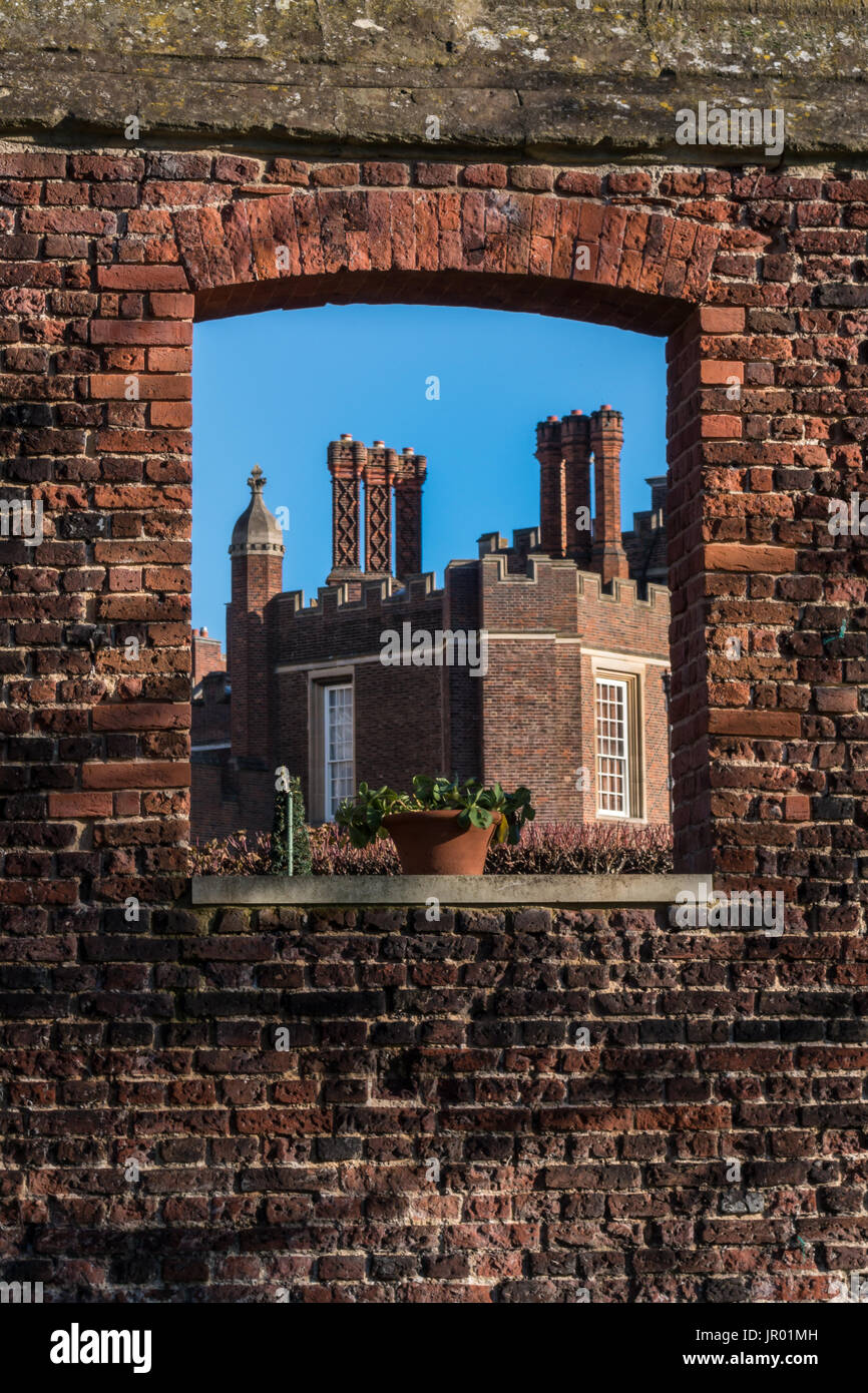 Detail of chimneys and parapet along the top of a Tudor building ...