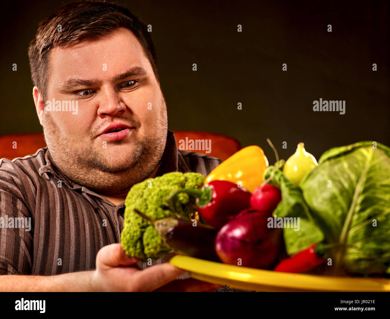 Diet fat man eating healthy food . Healthy breakfast with vegetables ...