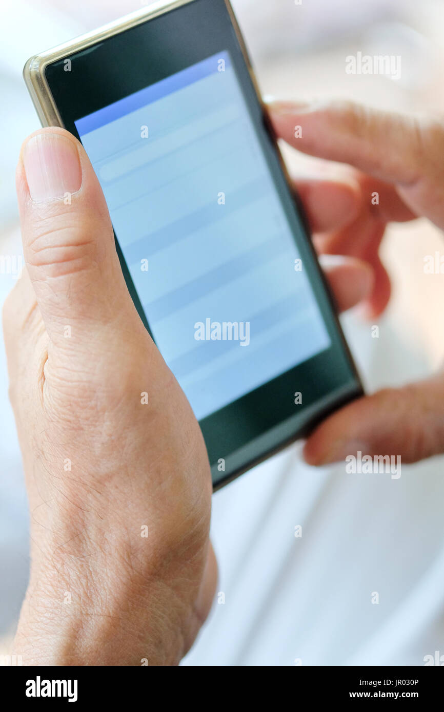 Close up of older man checking his phone background Stock Photo - Alamy