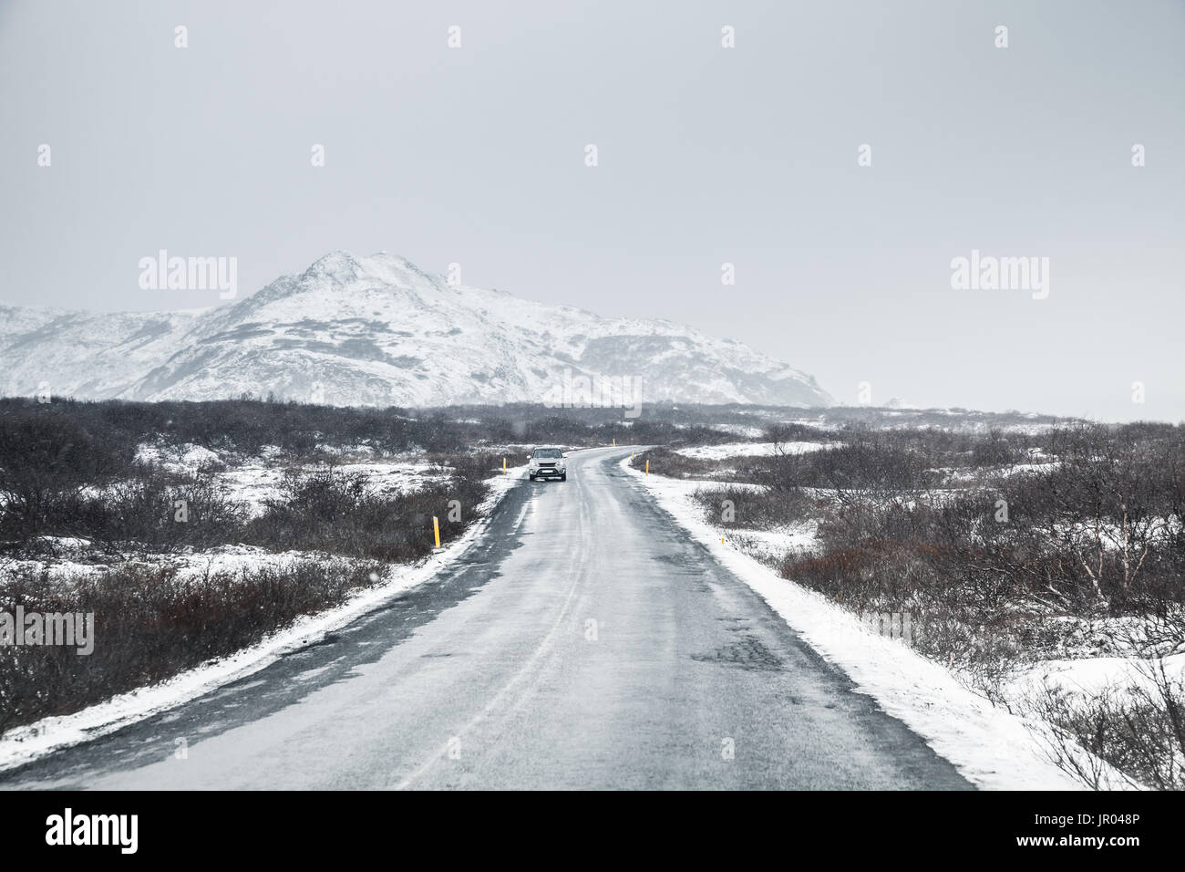Icelandic road covered with ice and snow, rural landscape with snowy ...