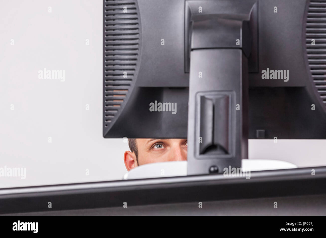 Interesting image of the eye of a young man looking to the monitor at ...