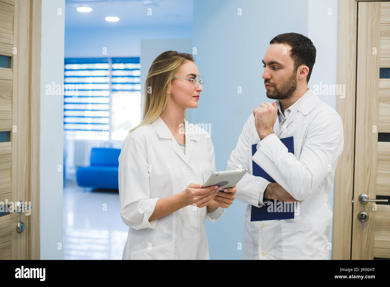 Medical Staff Having Discussion In Modern Hospital Corridor Stock Photo ...