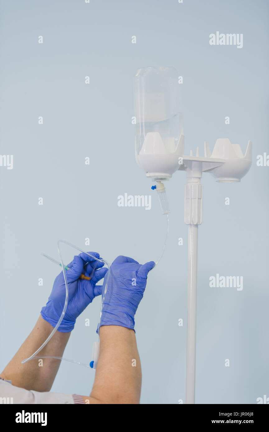 Doctor's hand and infusion drip in hospital on blurred background Stock ...
