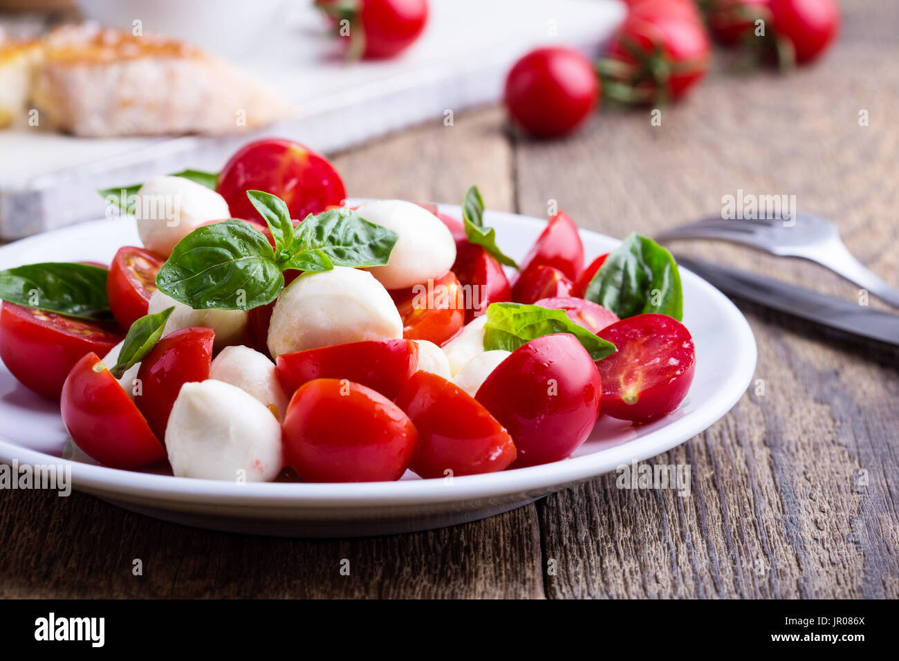 Traditional caprese salad with cherry tomatoes, mozzarella and basil ...