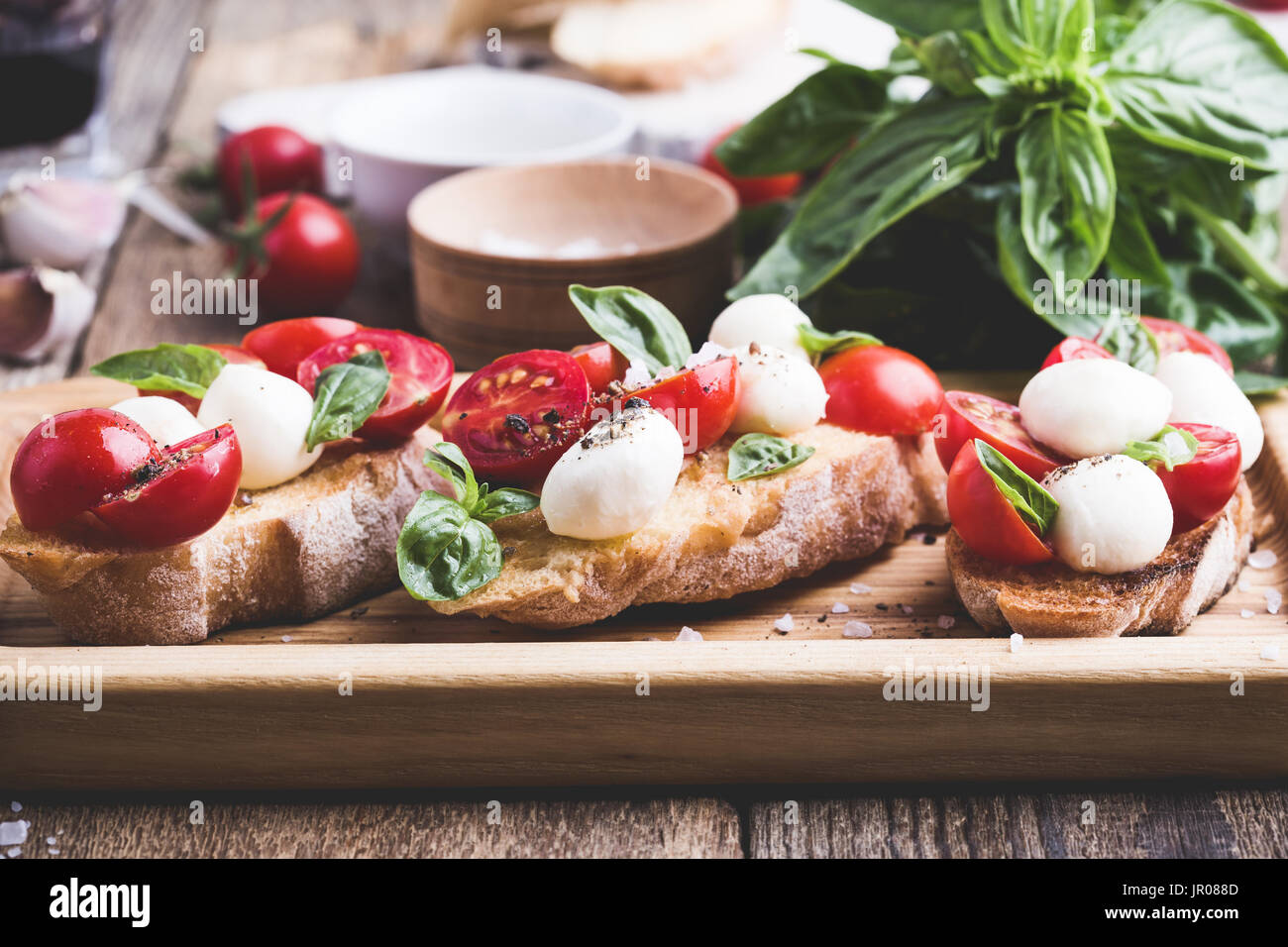 Homemade caprese bruschetta with flavorful cherry tomatoes, fresh basil ...