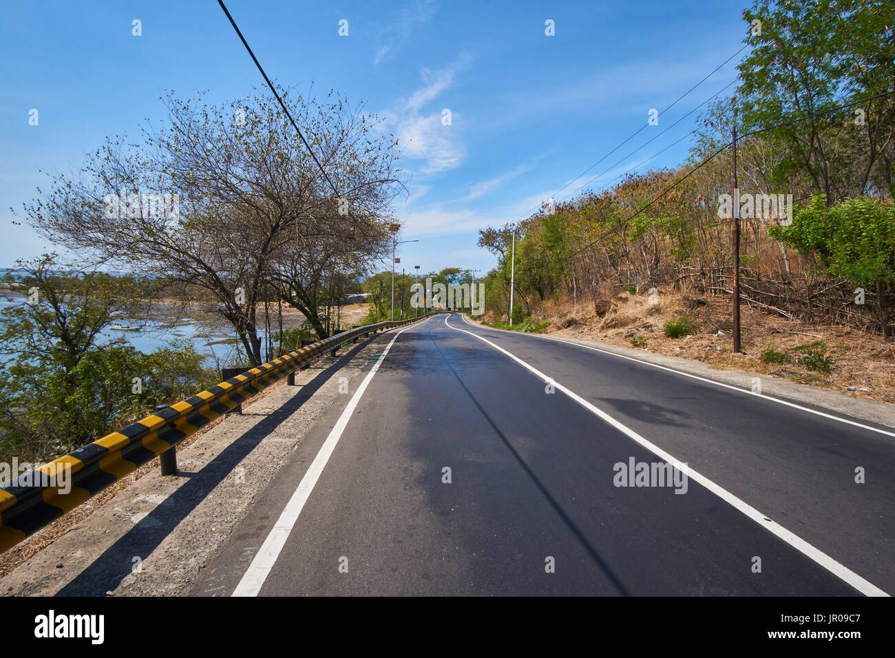 empty wide street at sumbawa indonesia Stock Photo - Alamy