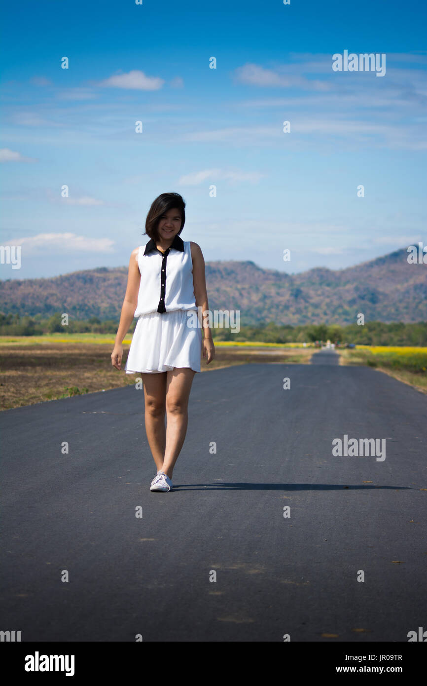 woman walking alone on the road Stock Photo - Alamy