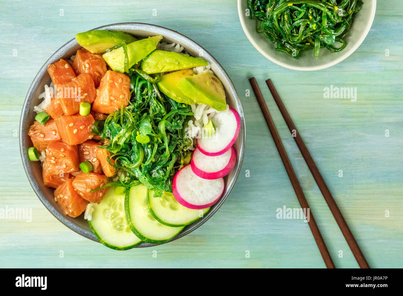 An overhead photo of poke, traditional Hawaiian raw fish salad, with a ...