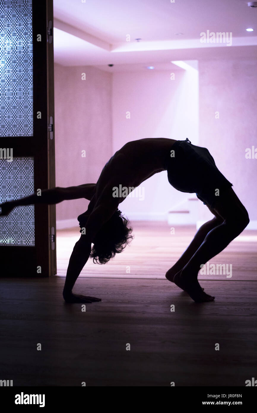 Yoga teacher doing backbend bridge flexibility and strength asana ...