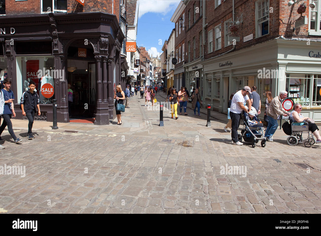 A busy street scene in york near Stonegate with shops pubs and people ...