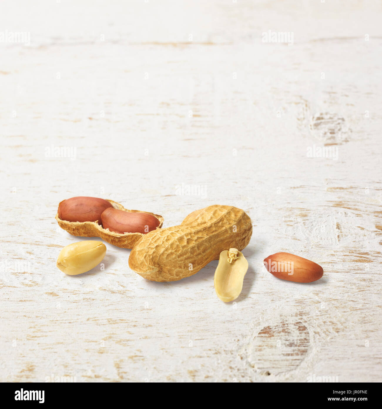 A Peanut Shell Opened In Half And Peanuts On A Painted White Wooden ...