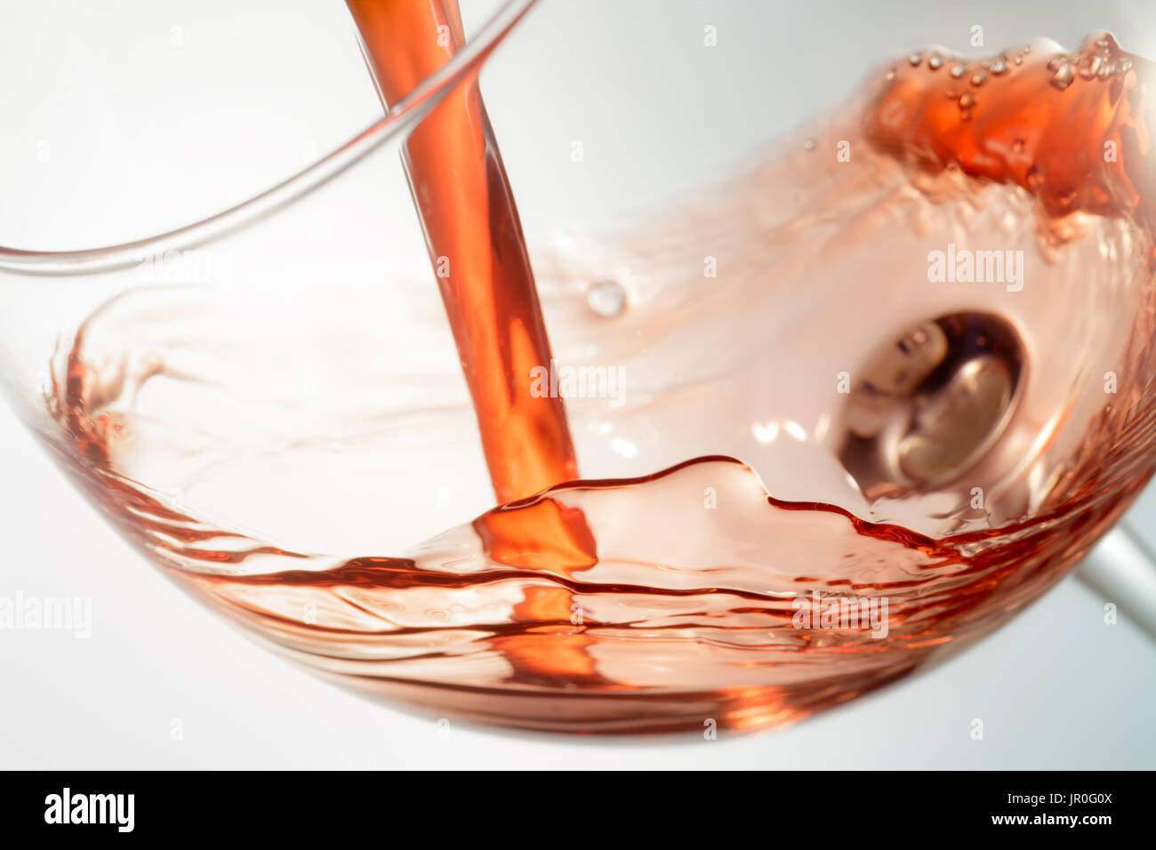 Wine splashing on glass isolated on white background Stock Photo - Alamy