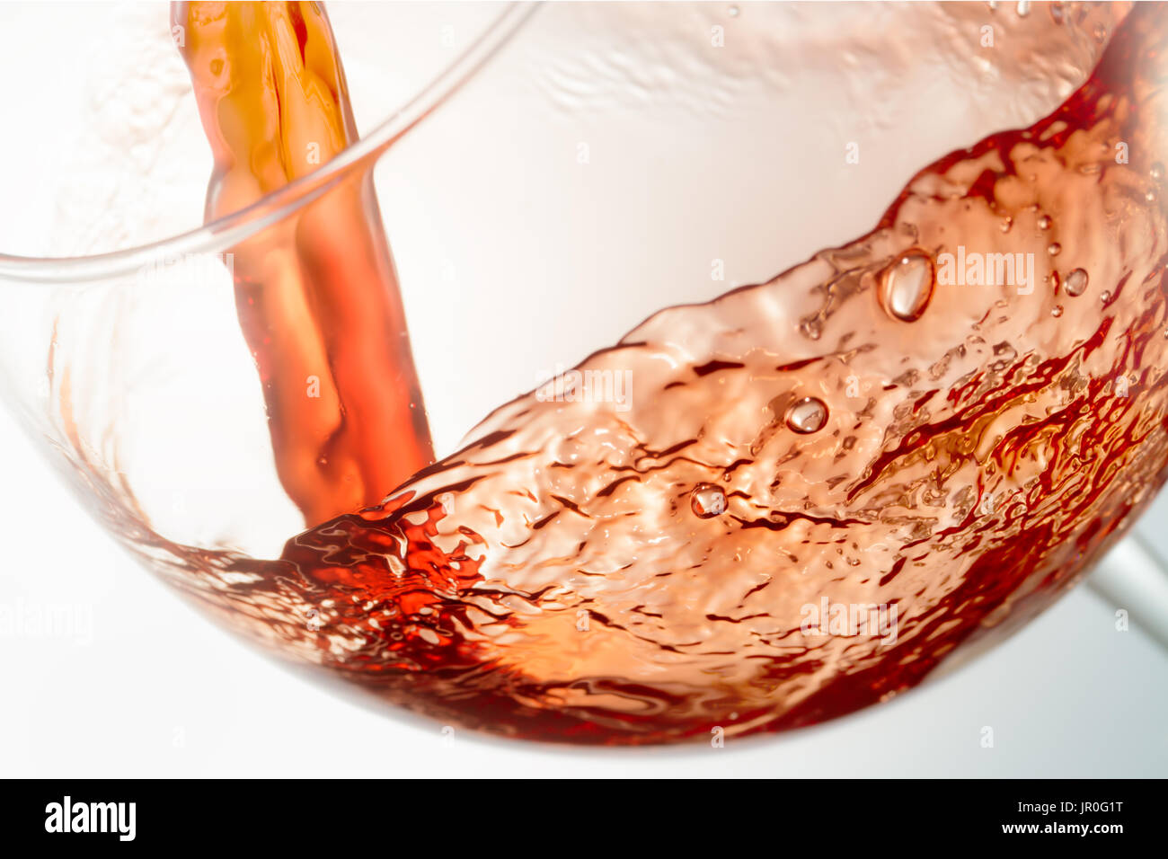 Wine splashing on glass isolated on white background Stock Photo - Alamy