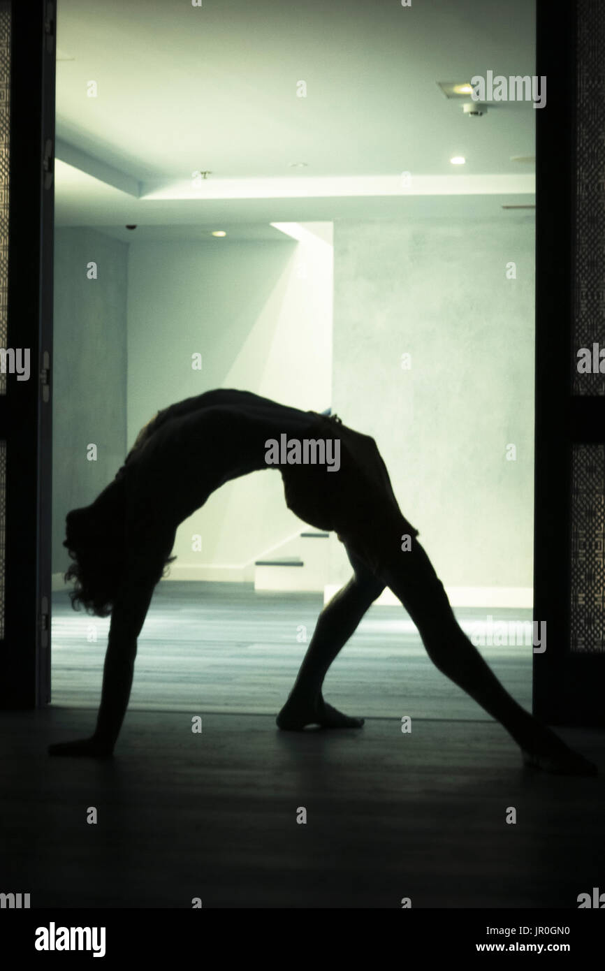 Yoga teacher doing backbend bridge flexibility and strength asana ...