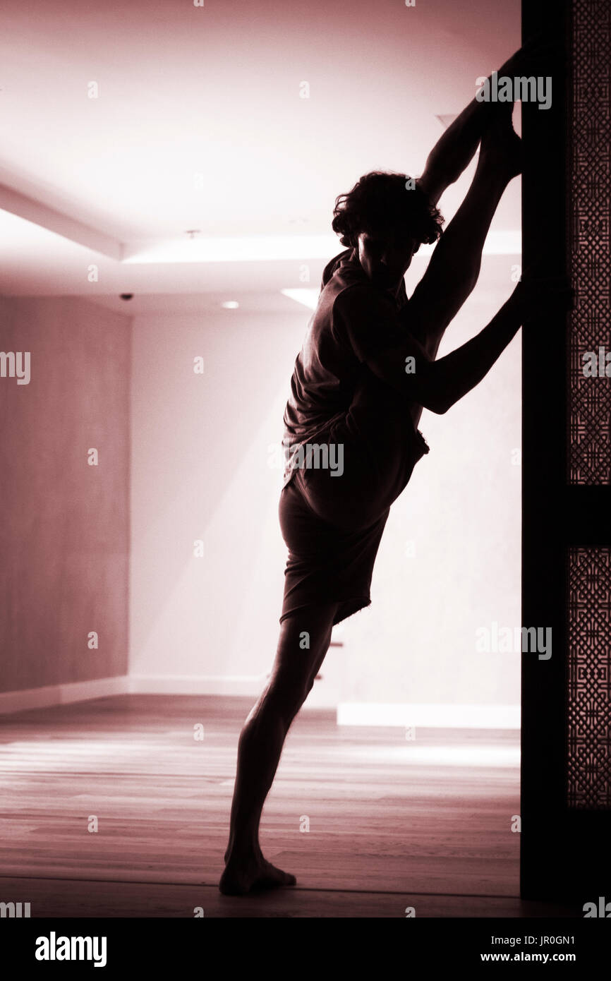 Male yoga teacher doing splits leg stretching flexibility calisthenics ...