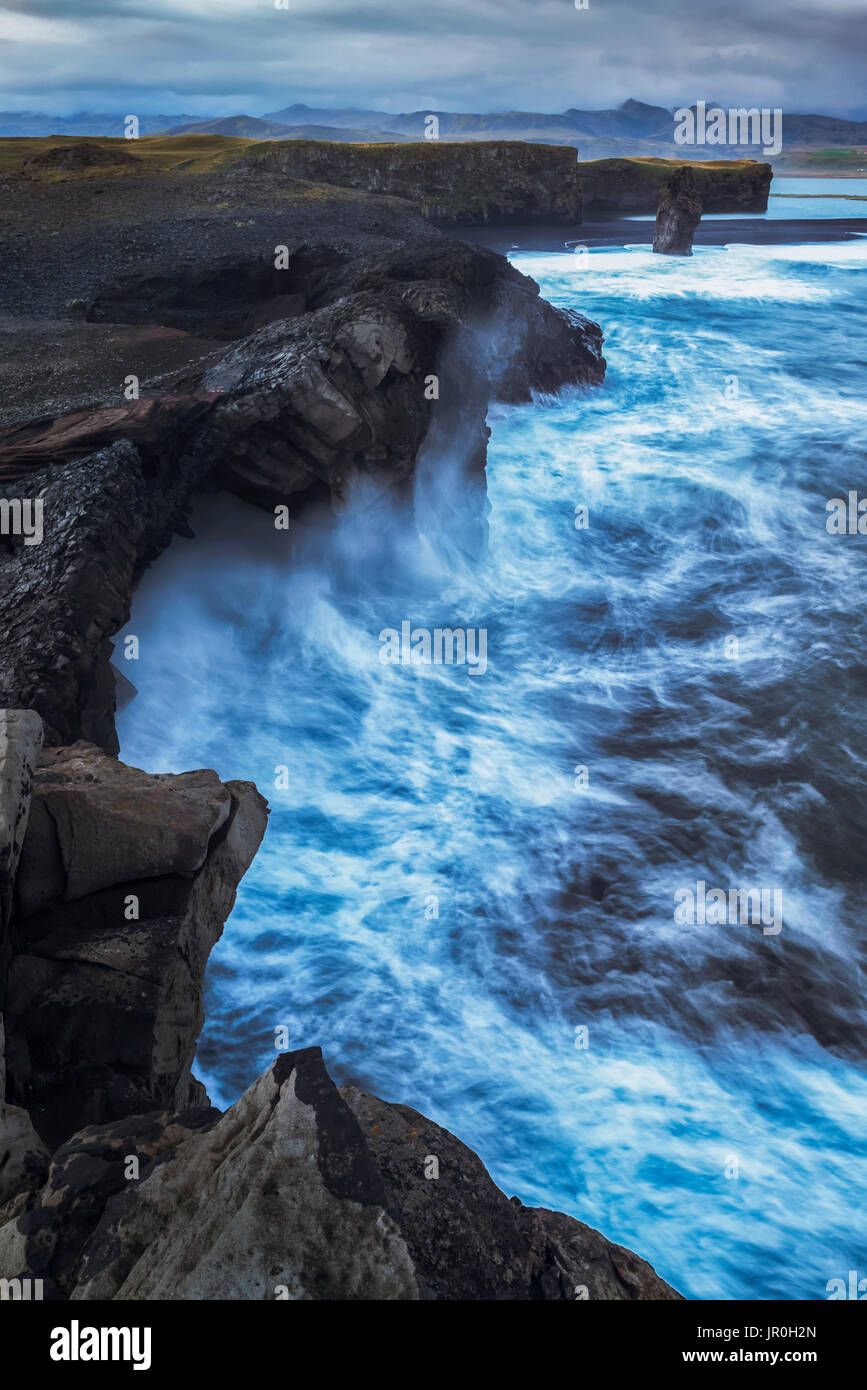 Large Waves Splash Against The Cliff Sides Of Dryholaey, Southern ...