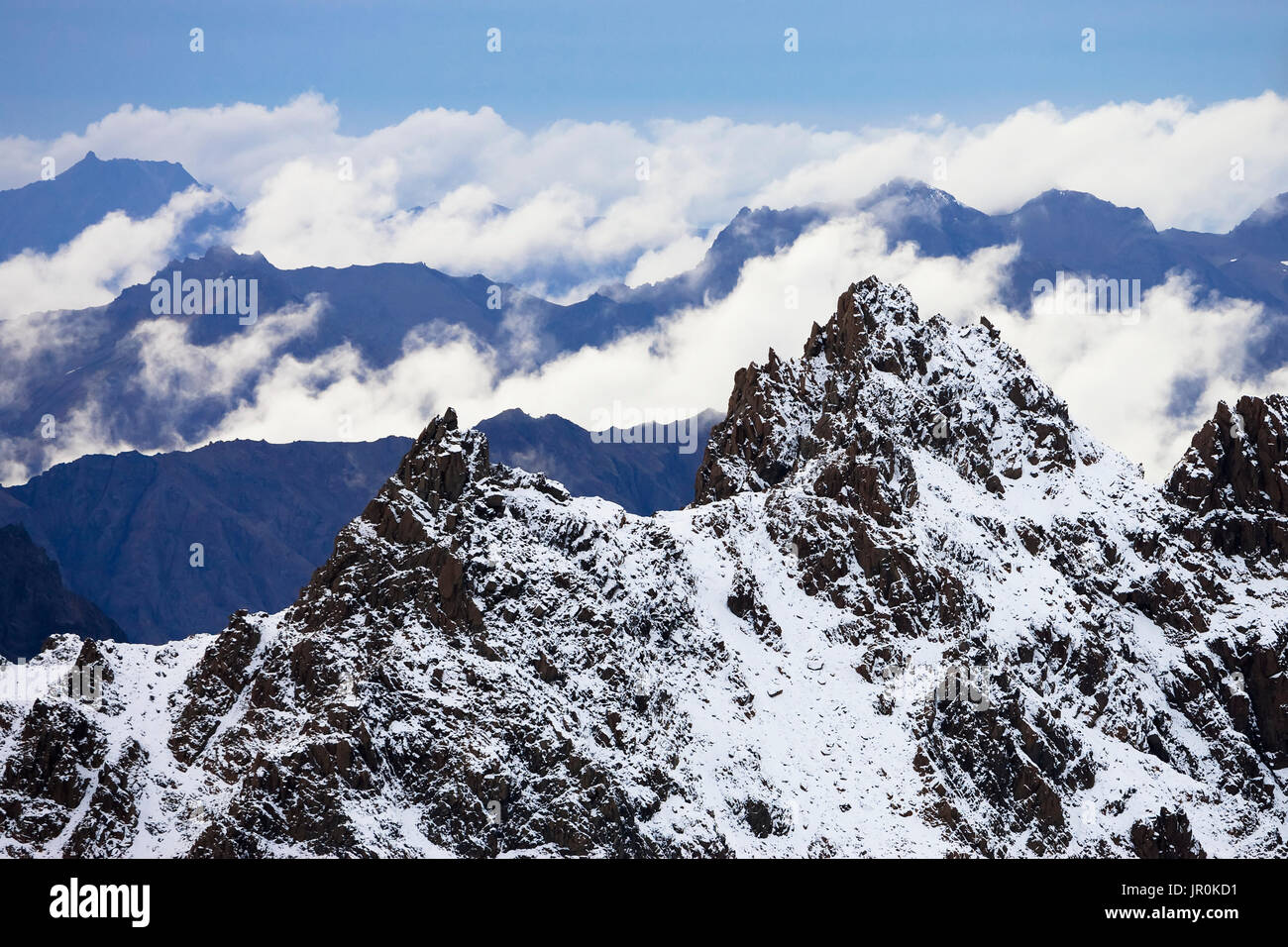 Rugged Snow Covered Peaks Of The Kenai Mountains With Blue Sky And ...